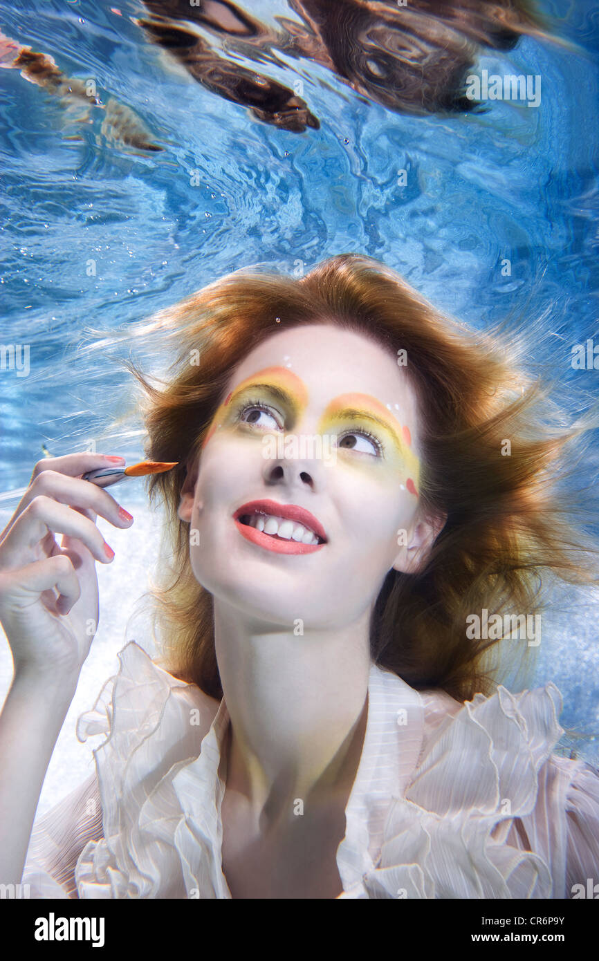 Caucasian putting makeup on under water Stock Photo - Alamy
