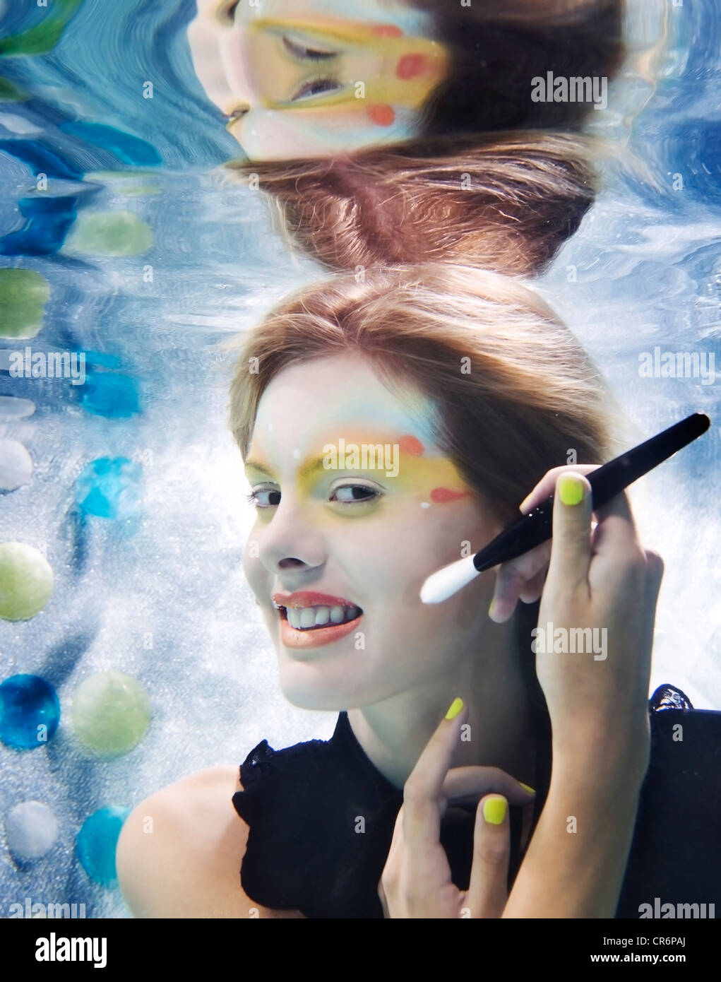 Caucasian putting makeup on under water Stock Photo - Alamy