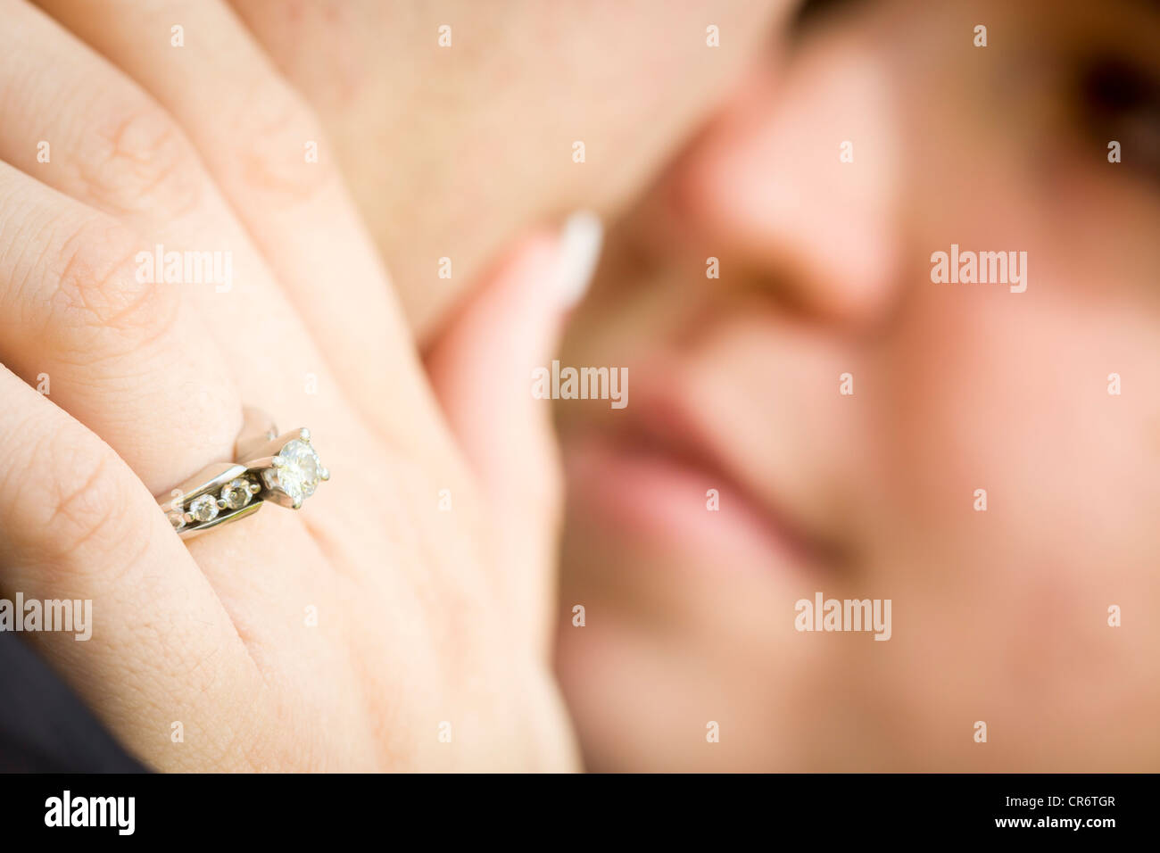 Young Female Hand with Engagement Ring Touching Fiance's Face with ...