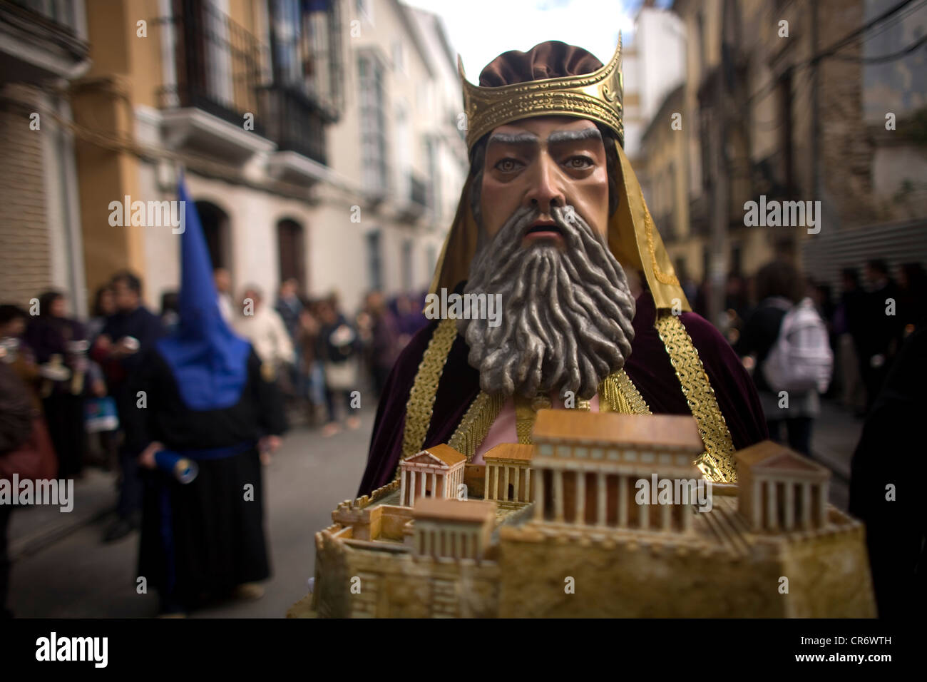 A masked man dressed as a biblical character holds a relic during an ...