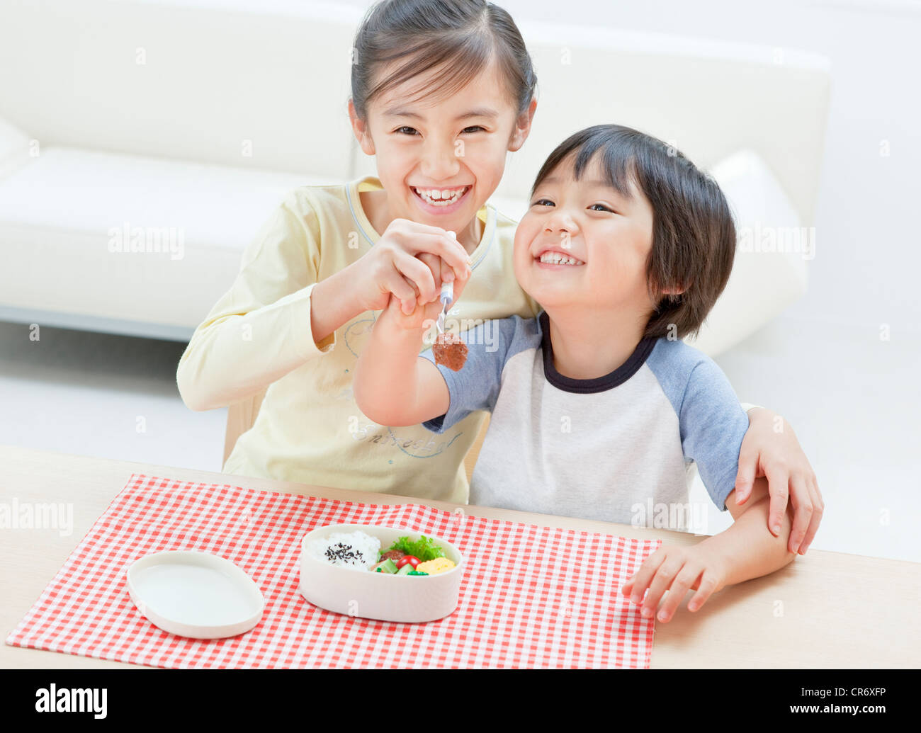 Brother and sister eating lunch Stock Photo - Alamy