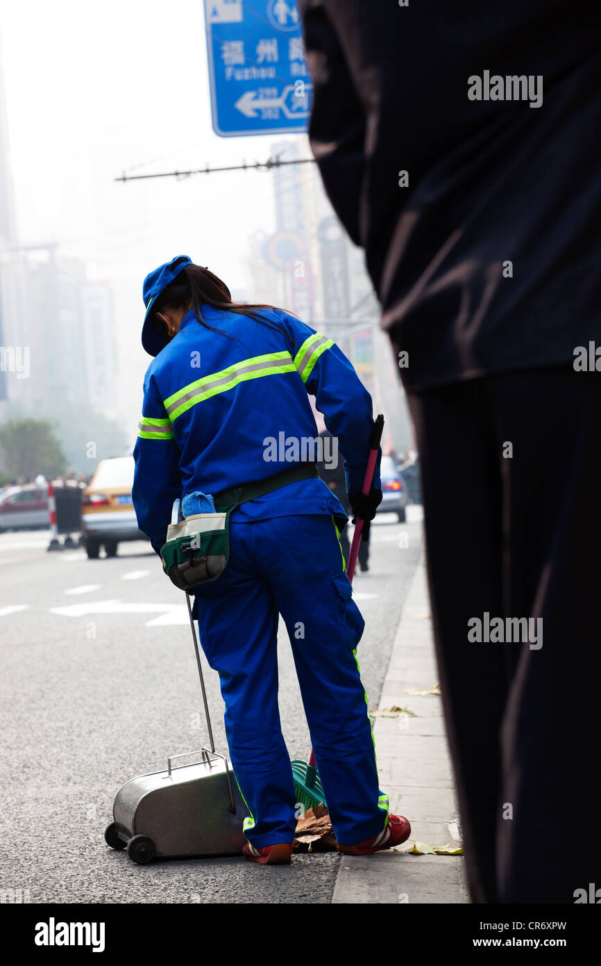 Back view of china street sweeper in blue uniform Stock Photo - Alamy