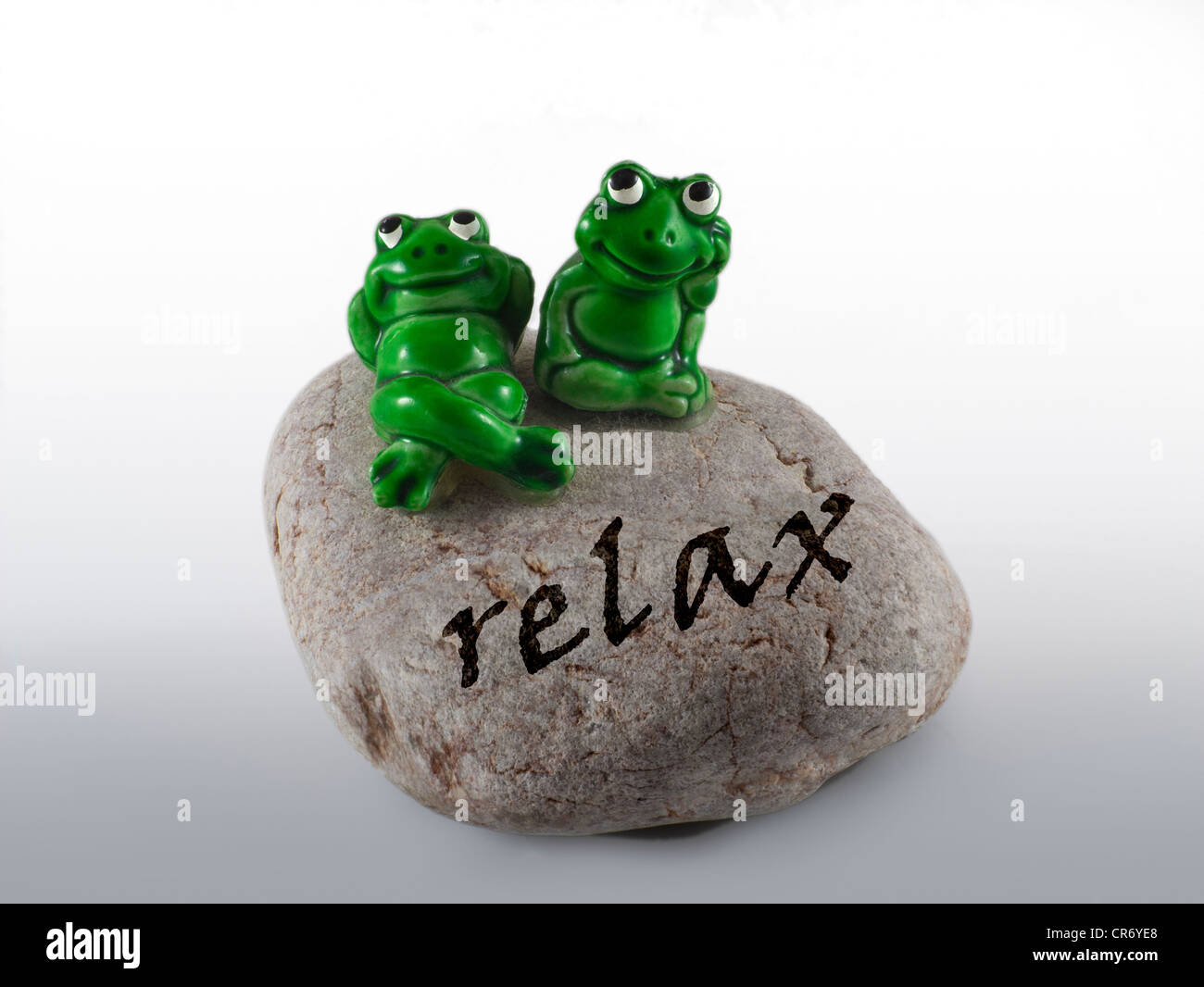 Frog figures on a stone with the inscription relax Stock Photo - Alamy