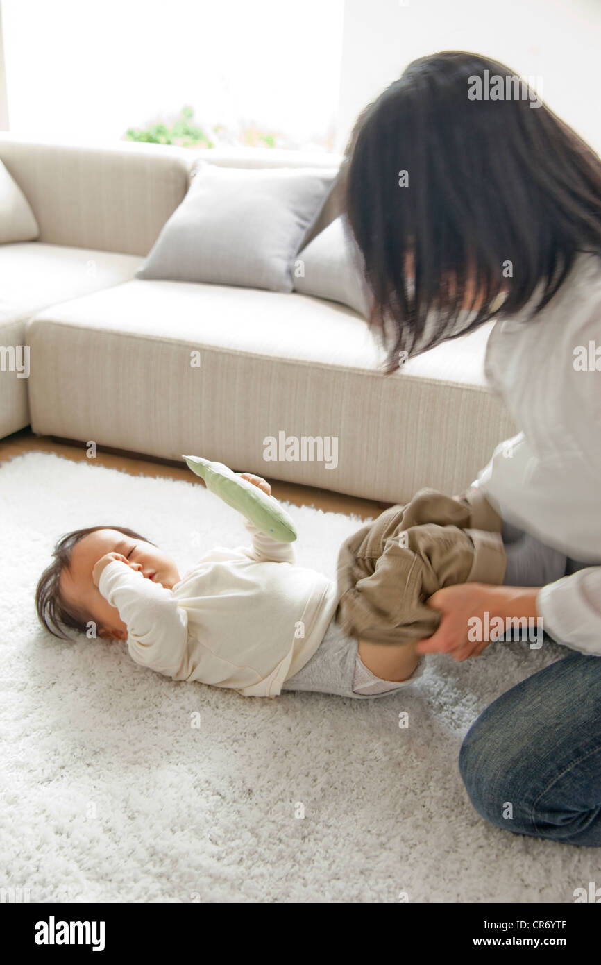 Mother changing diaper Stock Photo - Alamy