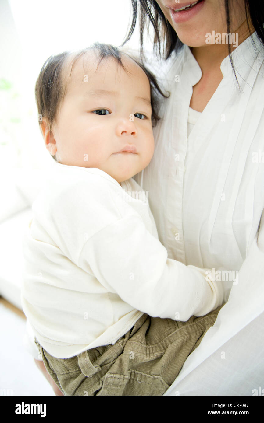 Baby hugging mother Stock Photo - Alamy