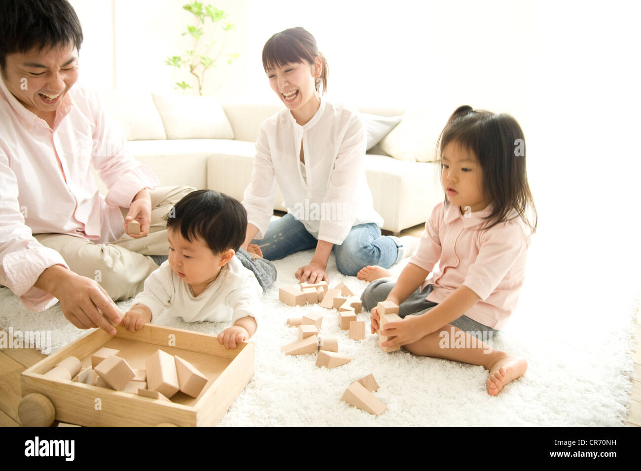 Family playing in living room Stock Photo - Alamy