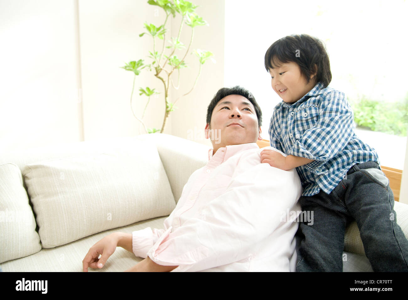 Father and son in living room Stock Photo - Alamy