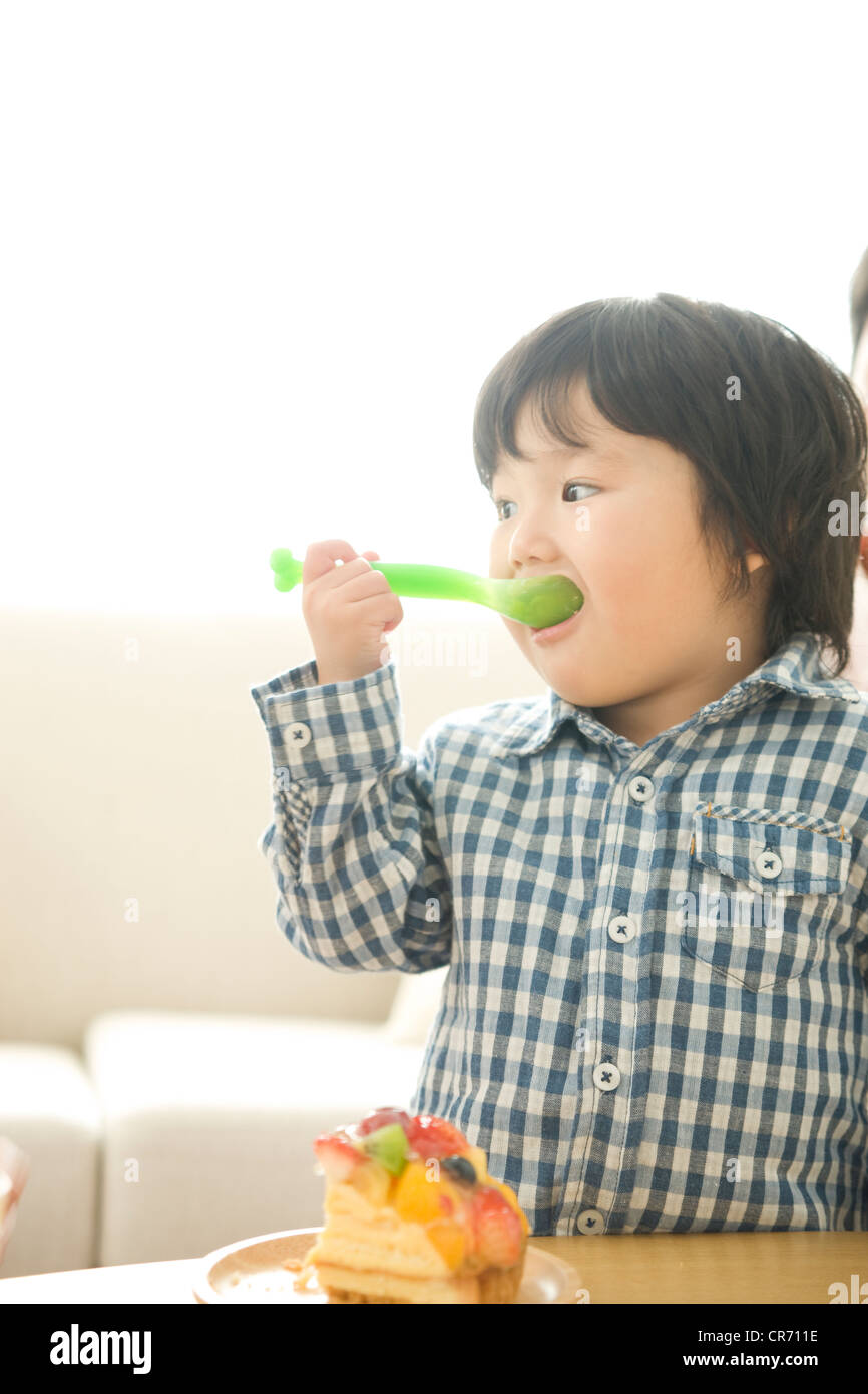 Boy eating cake Stock Photo - Alamy