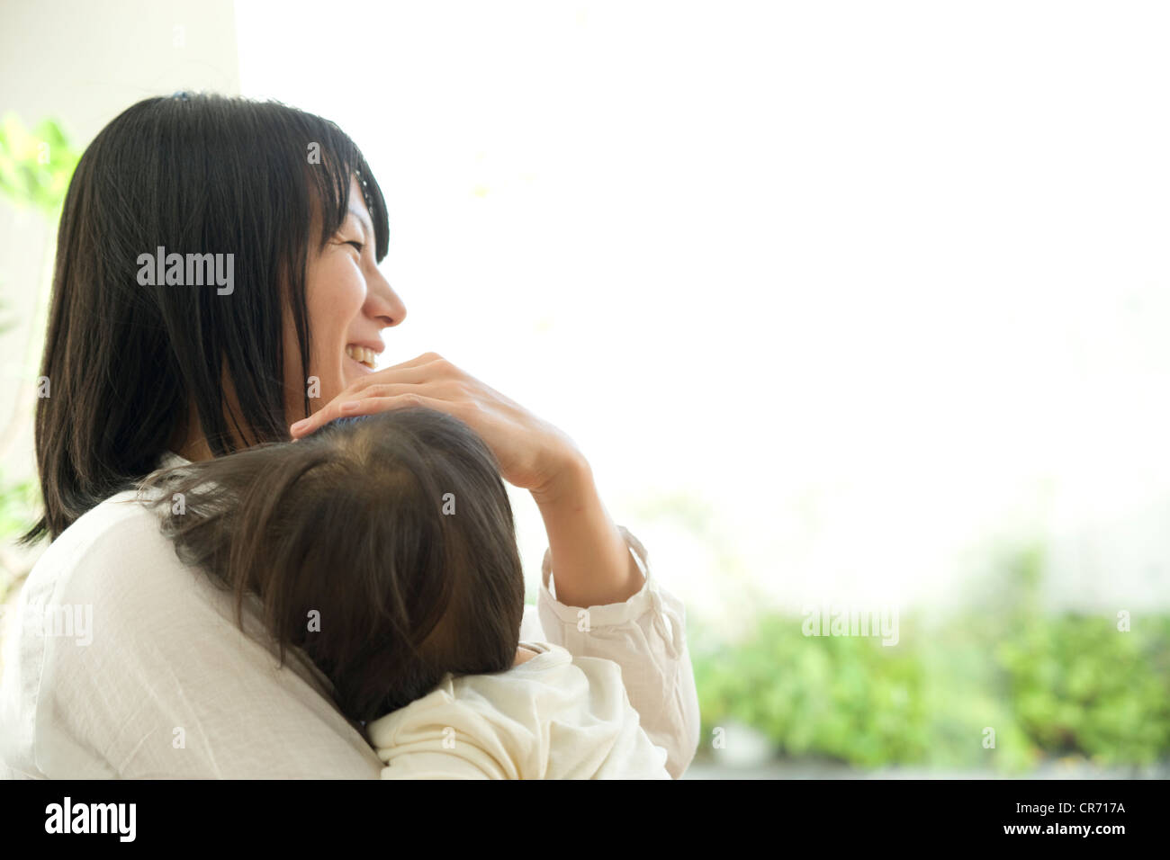 Mother hugging baby Stock Photo - Alamy