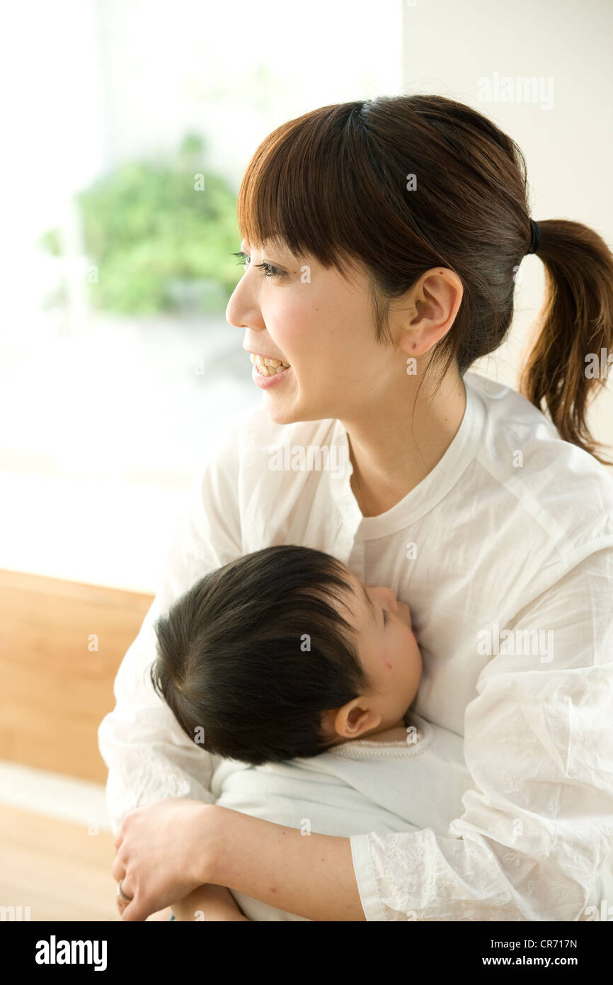 Mother hugging baby Stock Photo - Alamy