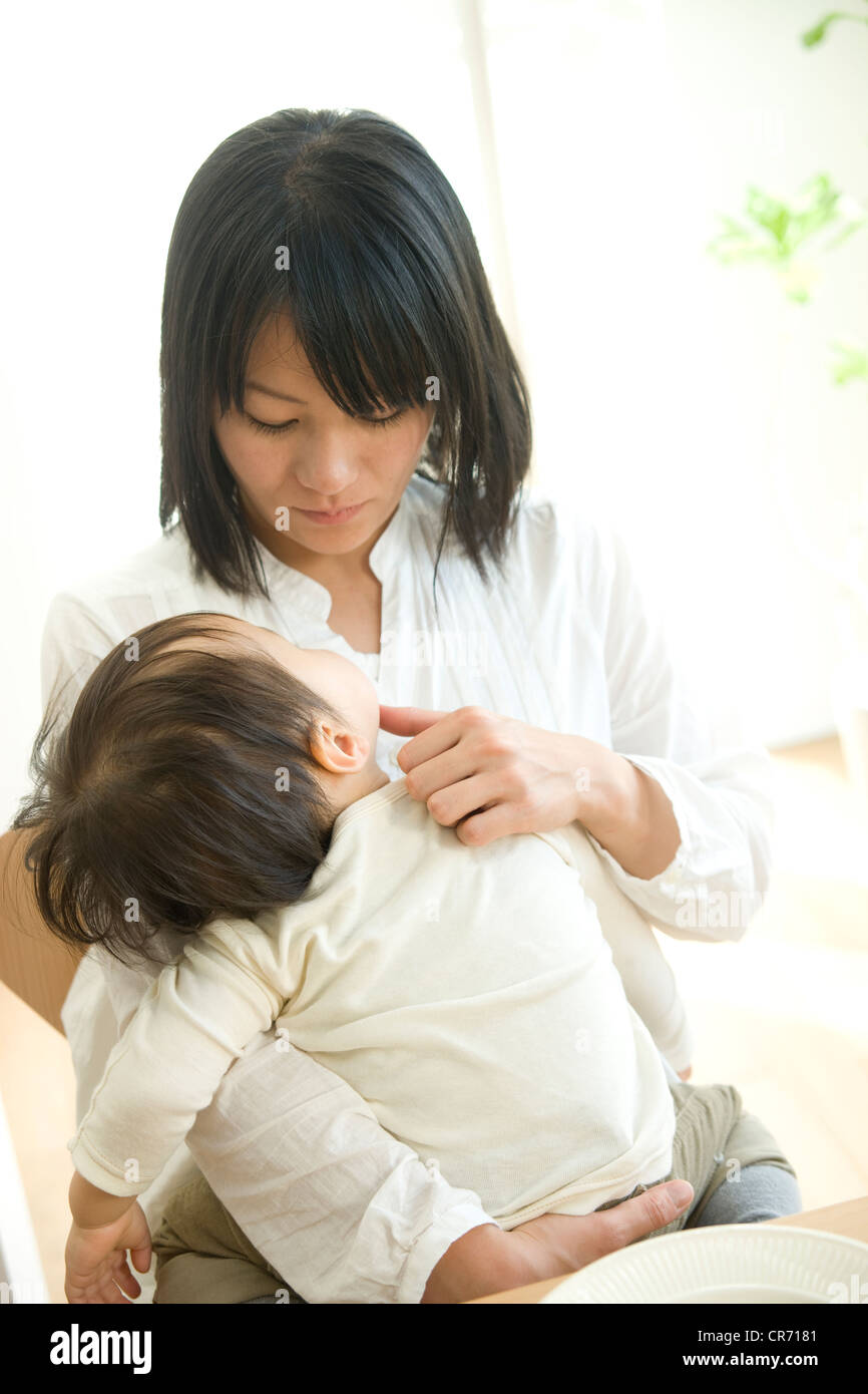 Mother hugging baby Stock Photo - Alamy