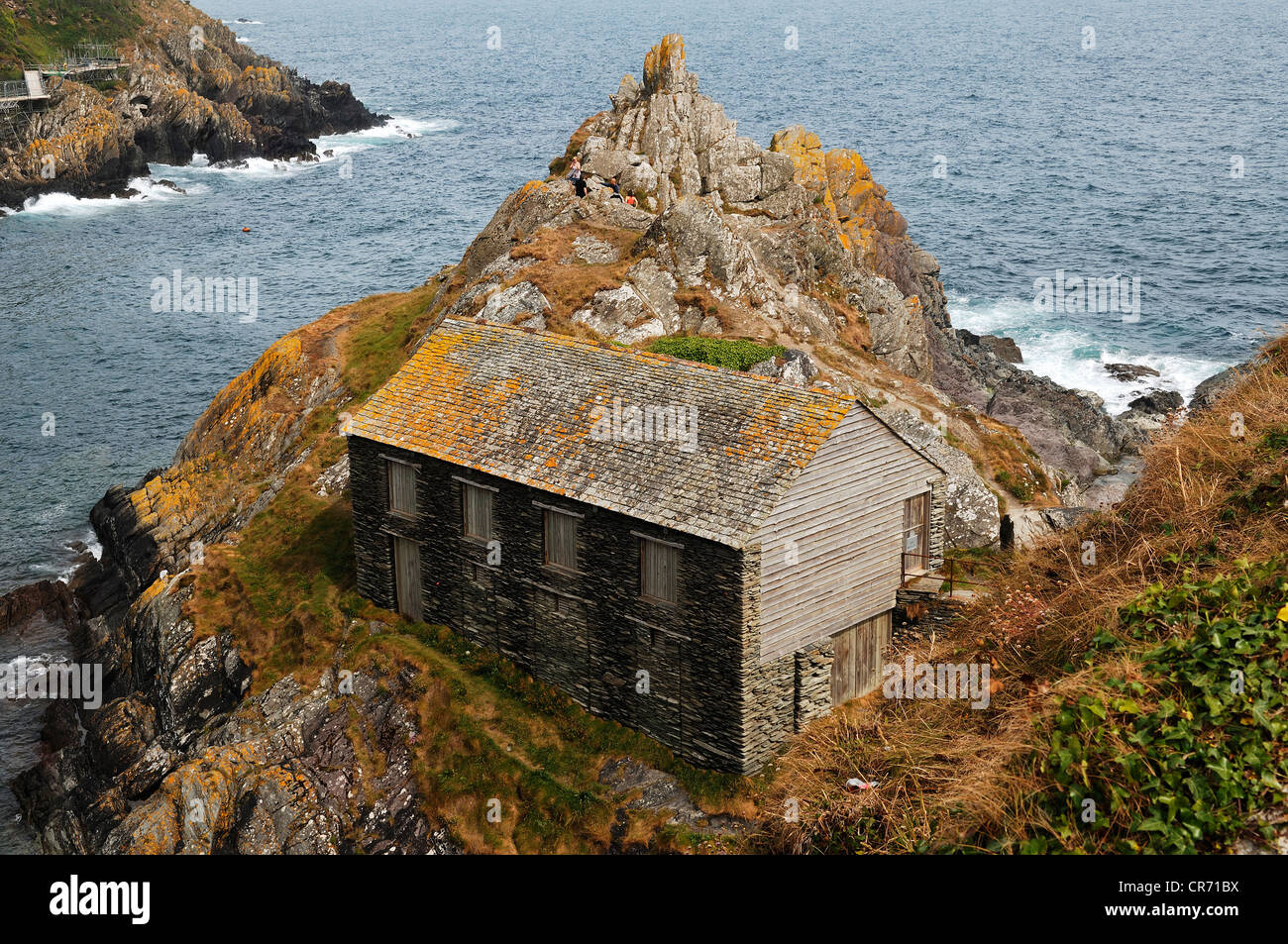 Old stone house at the entrance of the port of Polperro, Cornwall ...