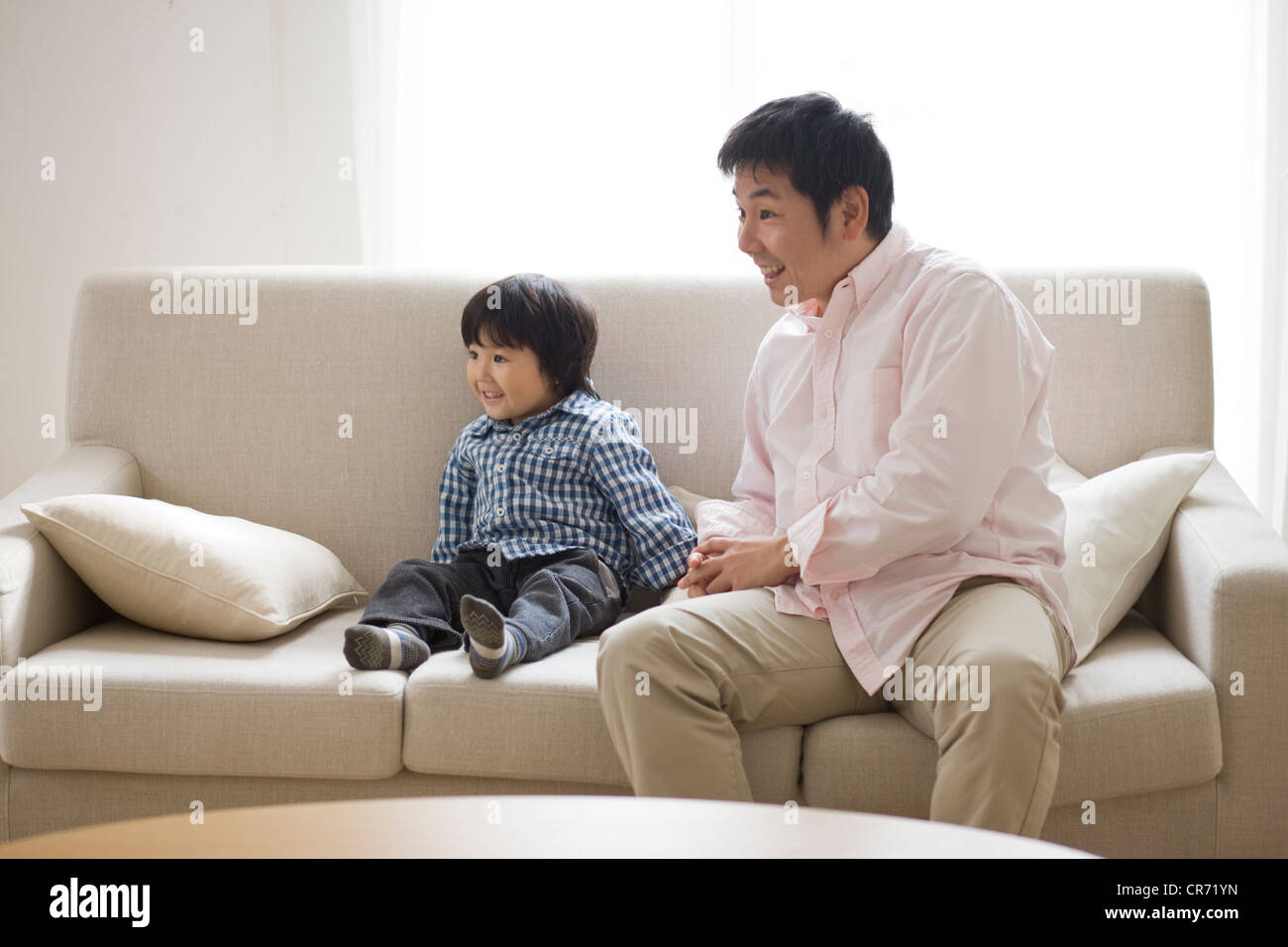 Father and son in living room Stock Photo - Alamy