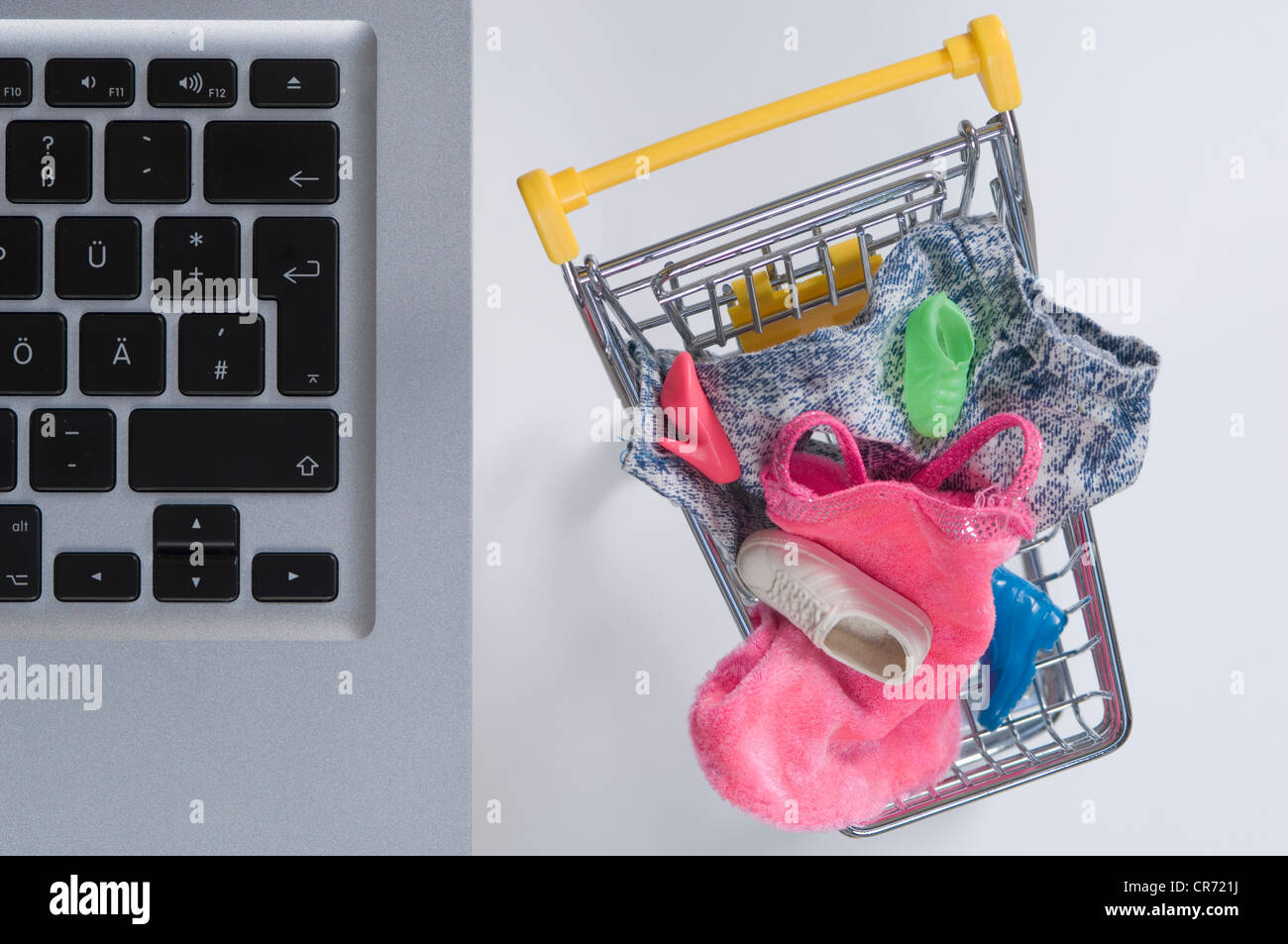 Laptop with shopping cart on white background Stock Photo - Alamy