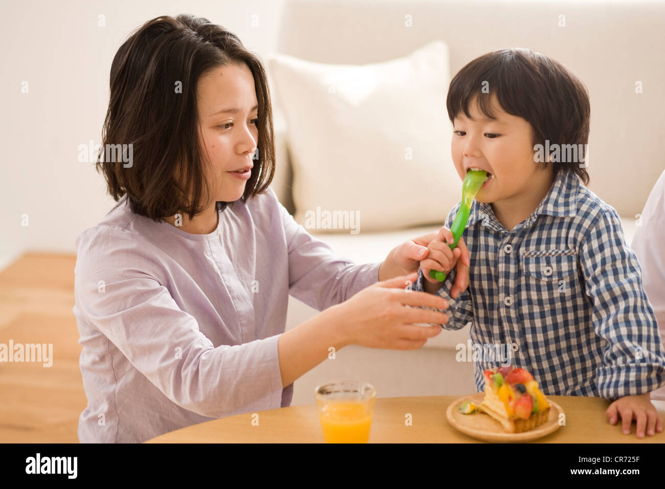 Mother and son eating cake Stock Photo - Alamy