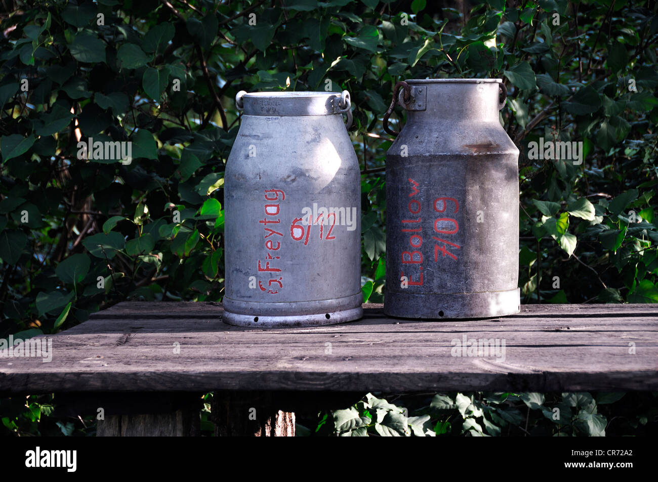 Two milk cans on a wooden pick-up board, Upahl, Mecklenburg-Western ...