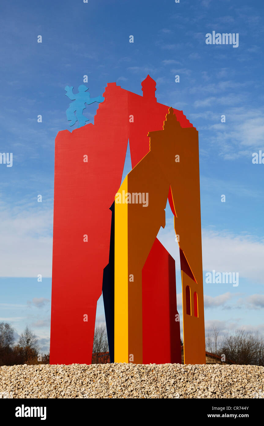 Coloured artwork made of steel plates on a traffic island in the middle ...