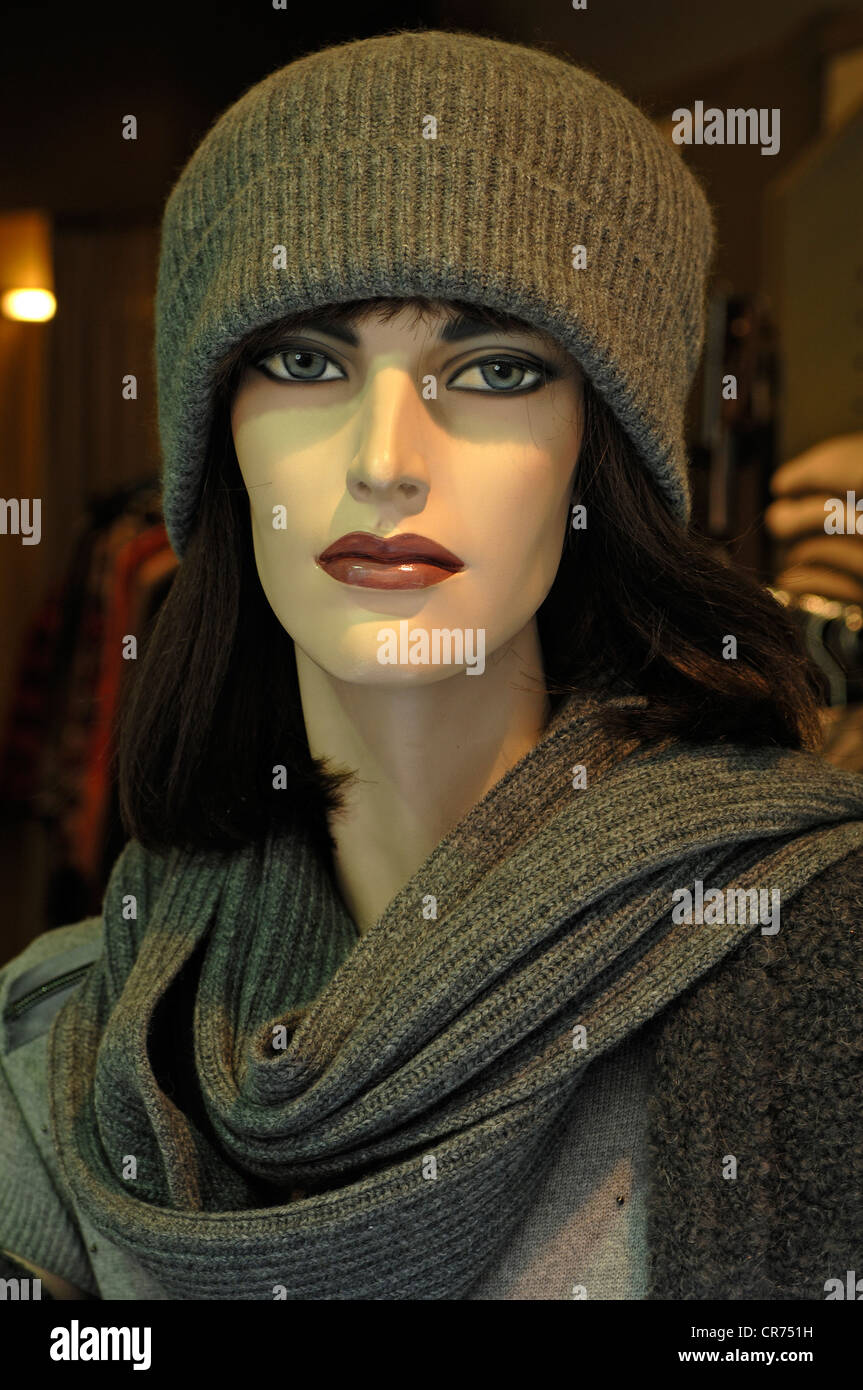 Female shop-window mannequin wearing a knitted cap in a fashion shop ...