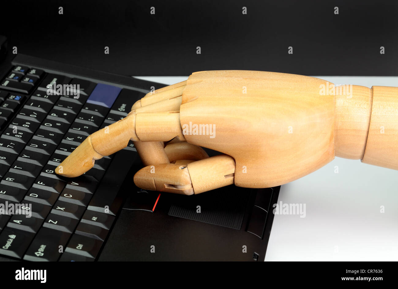 Concept of One finger typing by a wooden hand Stock Photo - Alamy