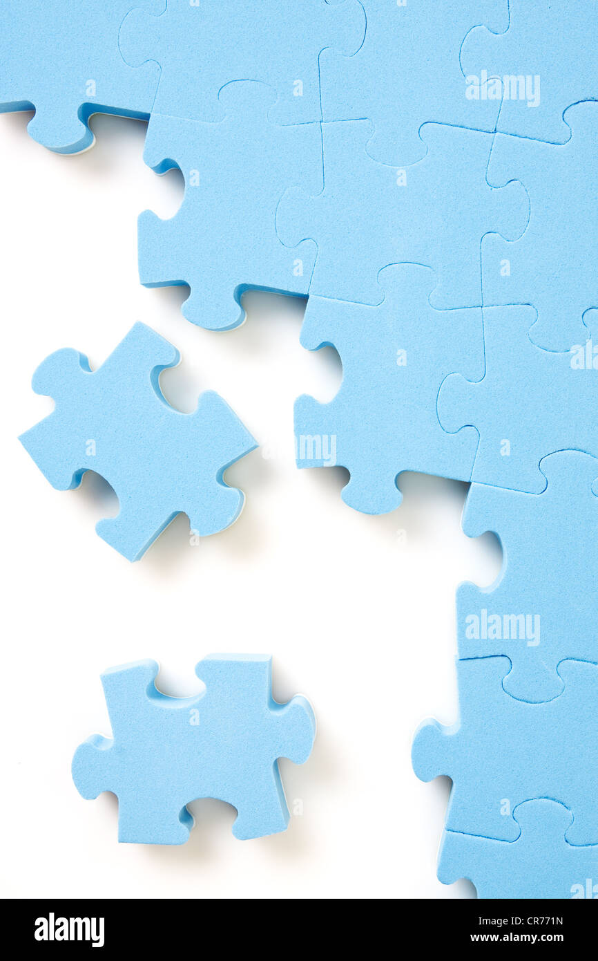 blue jigsaw puzzle pieces on white background Stock Photo - Alamy