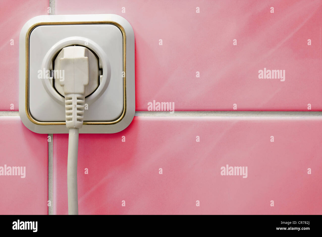 white outlet with a electric plug in a bathroom Stock Photo - Alamy