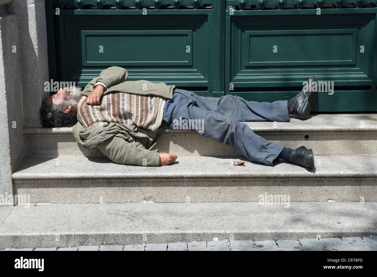 Homeless man 60 - 70 asleep on a door step in Porto, Portugal Stock ...