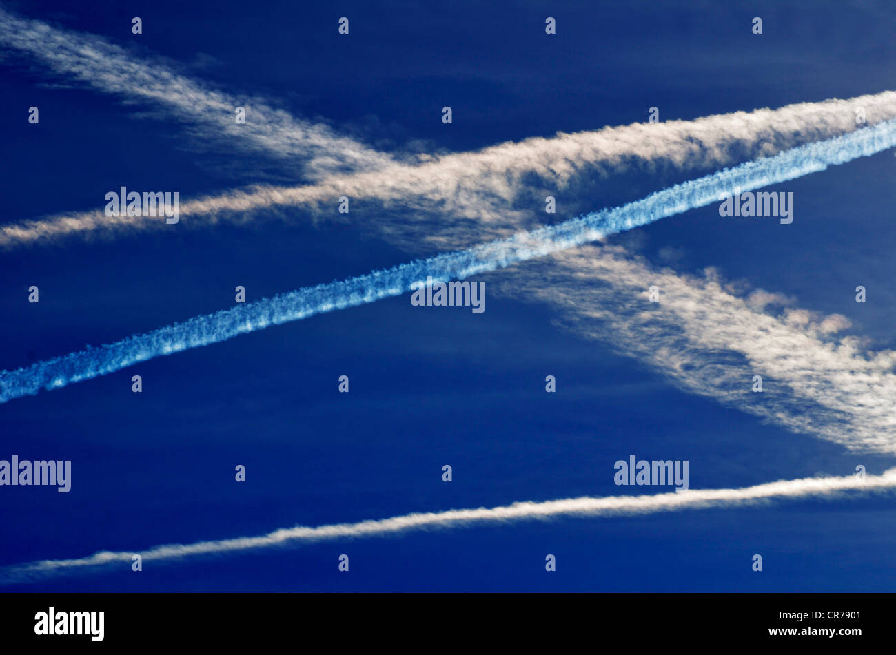 Contrails from aircraft in blue sky Stock Photo - Alamy
