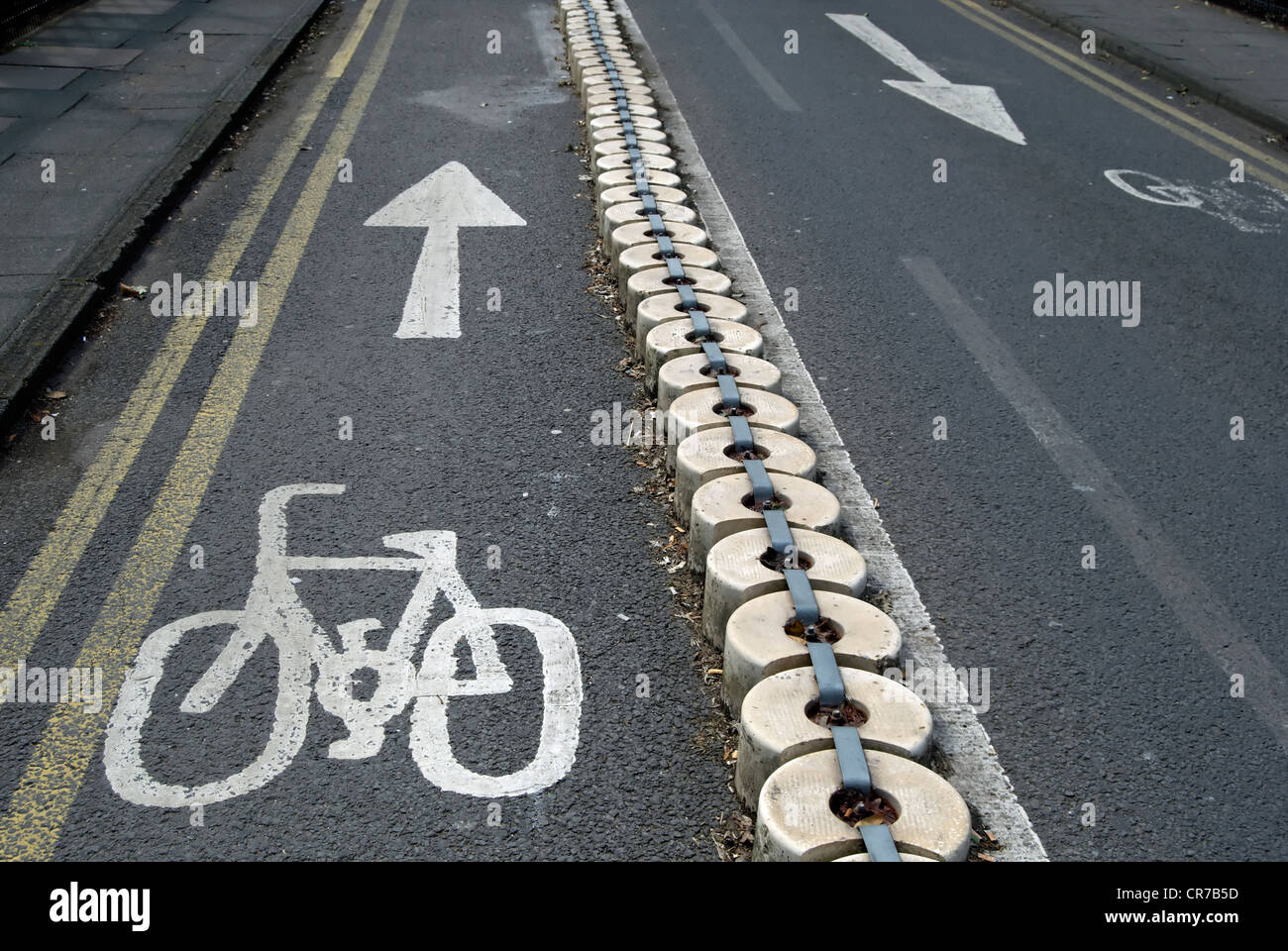 cycle lane separated from vehicular traffic by a line of concrete ...