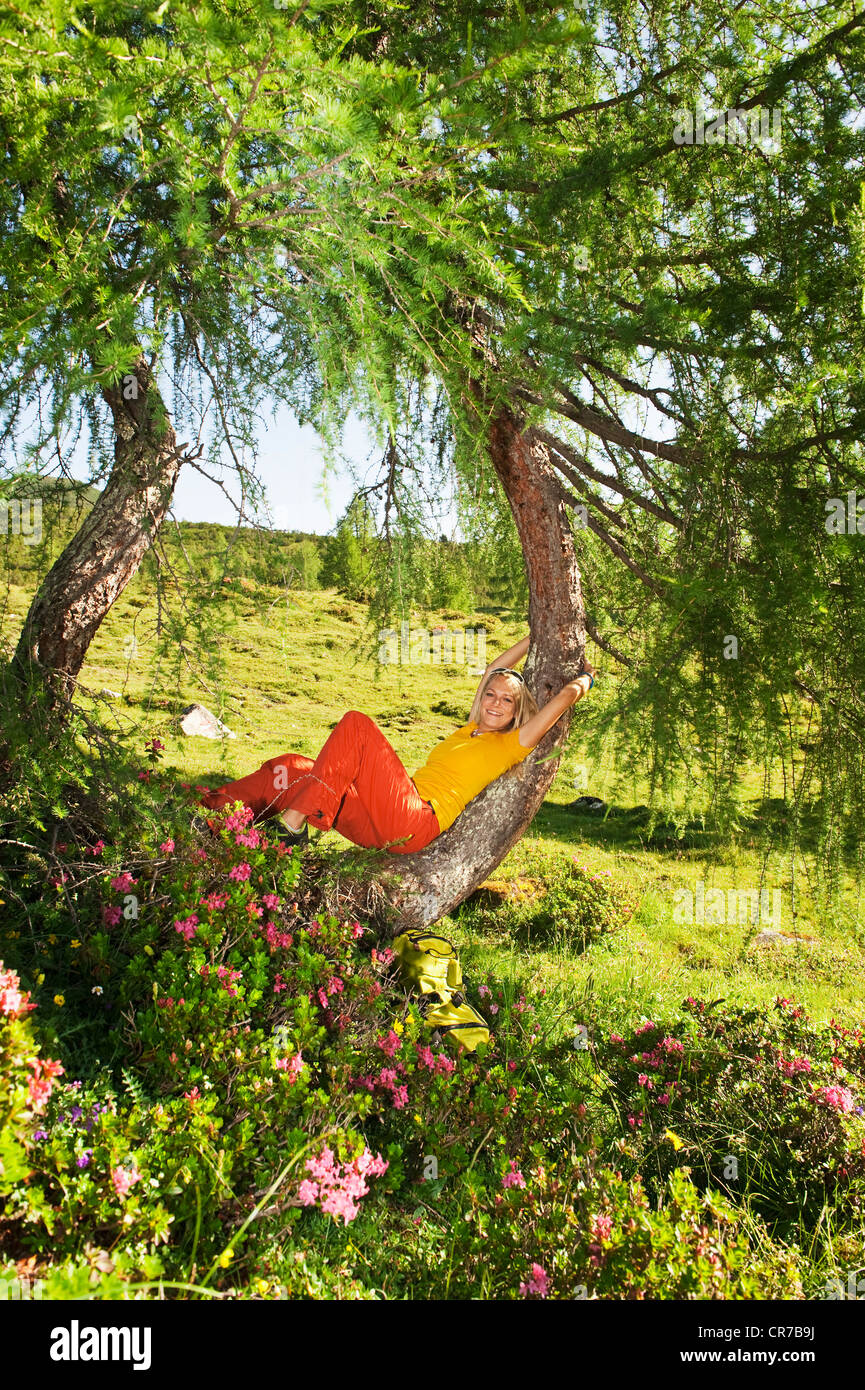Young woman lying on tree trunk hi-res stock photography and images - Alamy