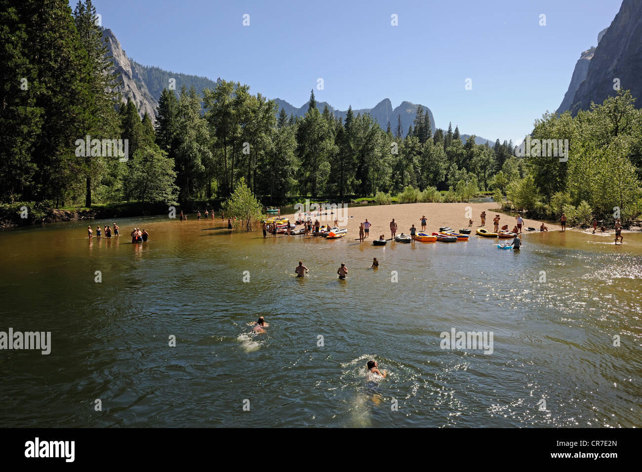 Tourists swimming in the Merced River in Yosemite National Park ...