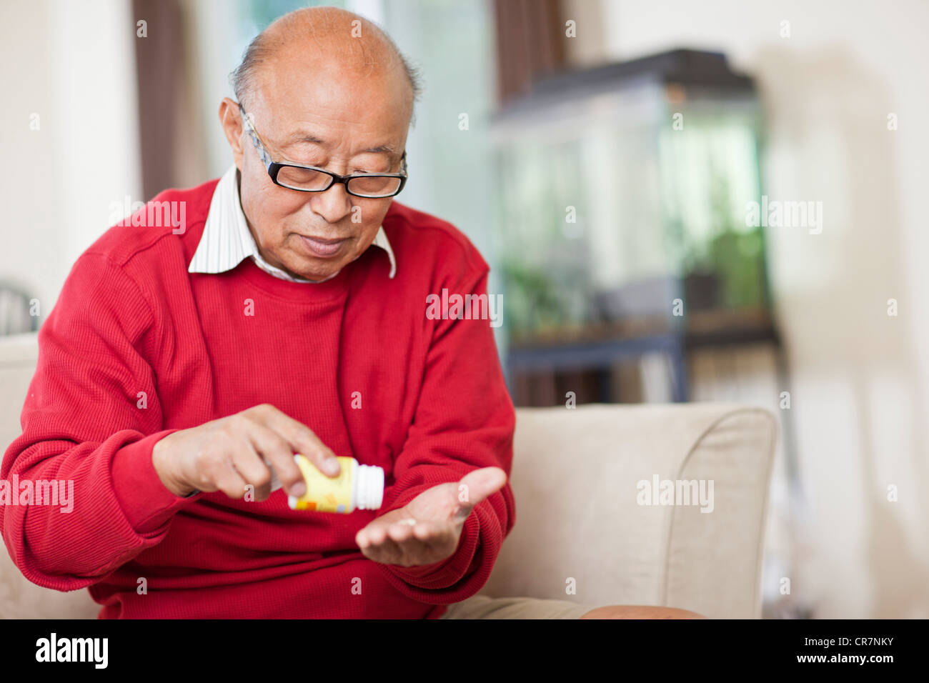 Chinese man taking medication Stock Photo - Alamy