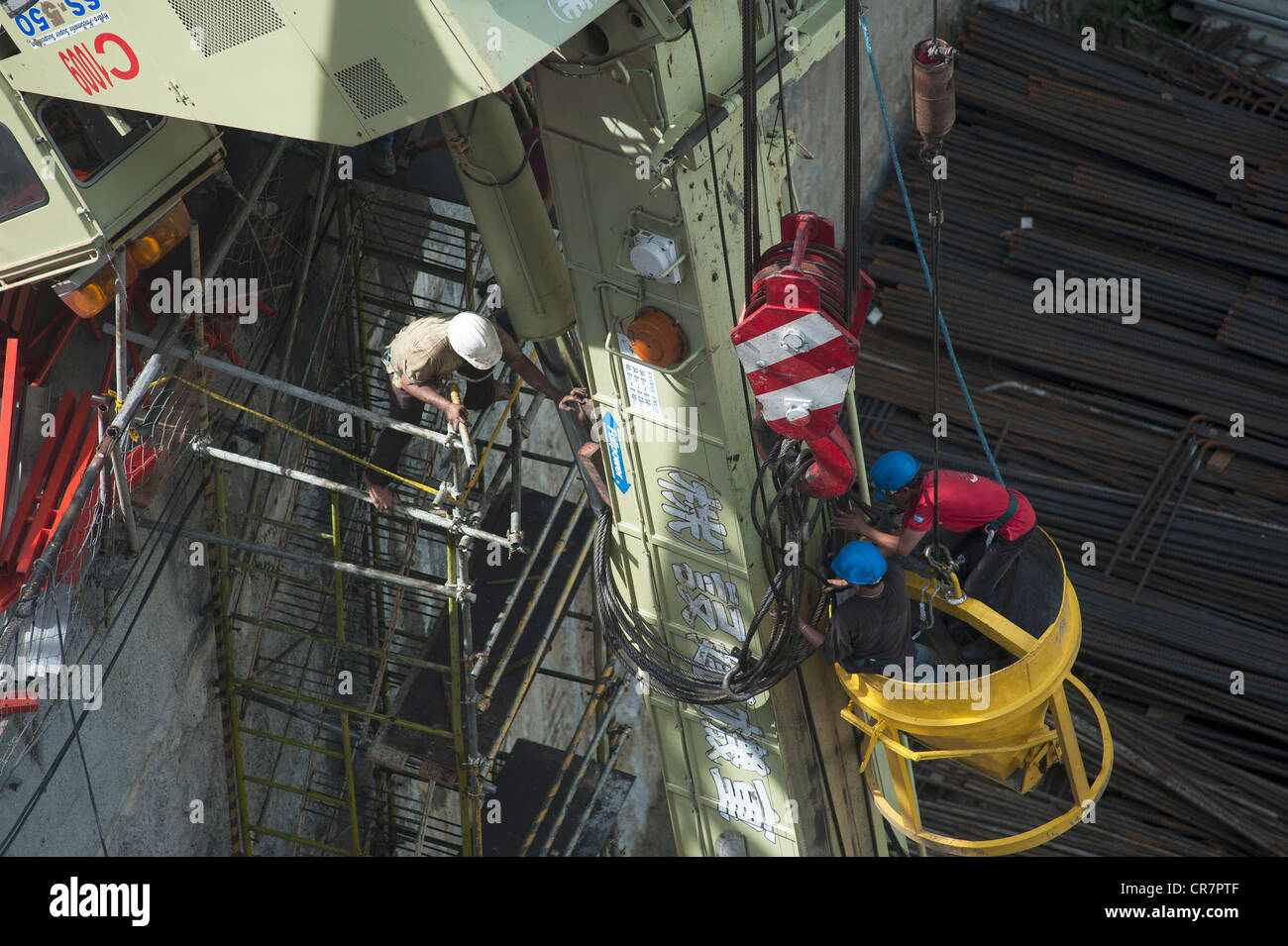 Crane trying to lift excavator out of Philippine construction site ...