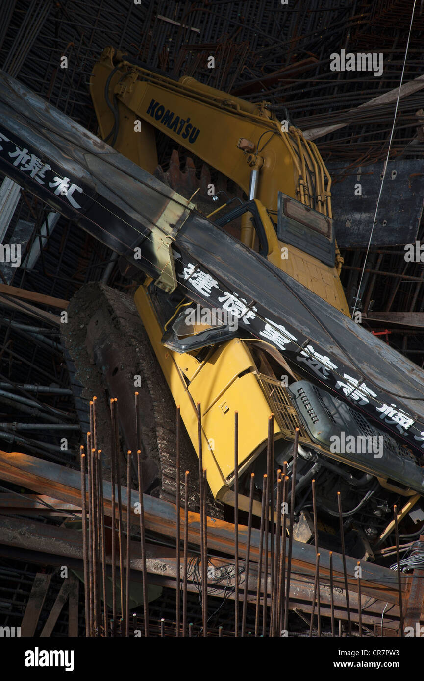 Crane trying to lift excavator out of Philippine construction site ...