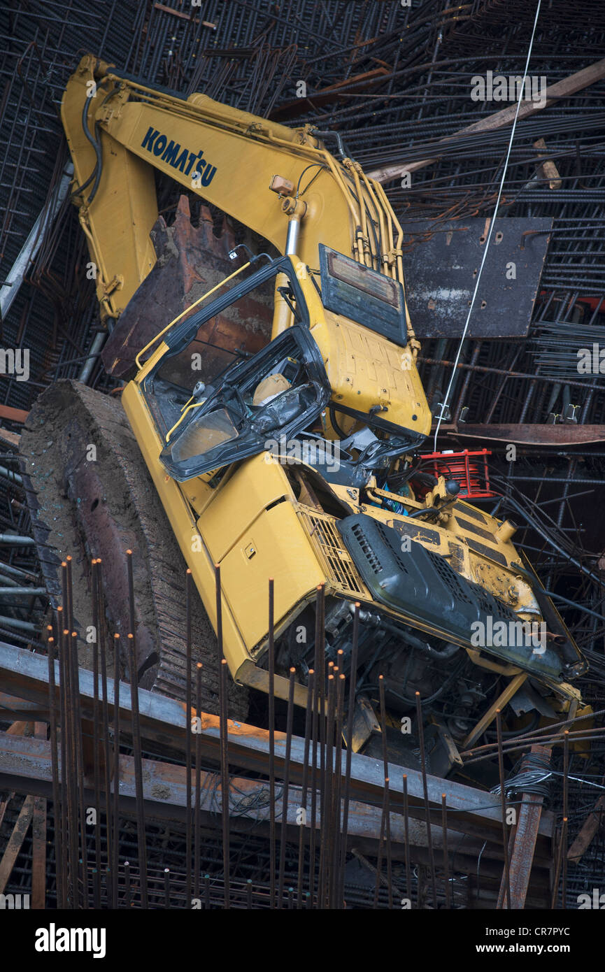 Crane trying to lift excavator out of Philippine construction site ...