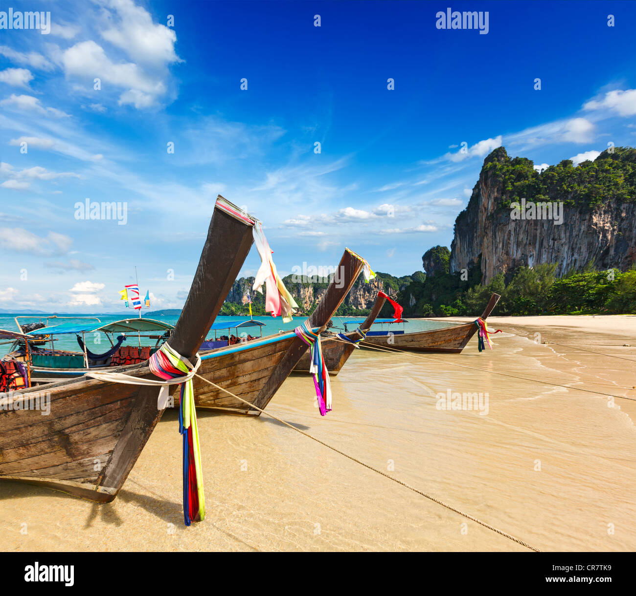 Long tail boats on tropical beach in Thailand Stock Photo - Alamy