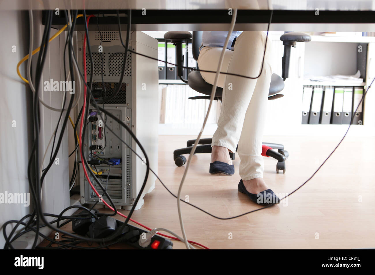 Cables under the desk in an office Stock Photo - Alamy