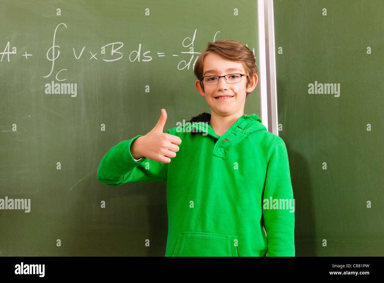 Education - Child or pupil at blackboard in school in math, the kid is ...
