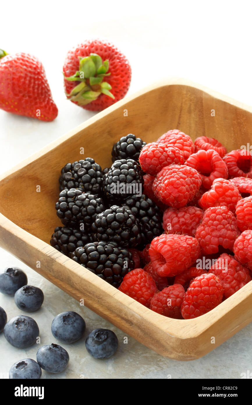 Assorted fresh berries in wooden bowl Stock Photo - Alamy