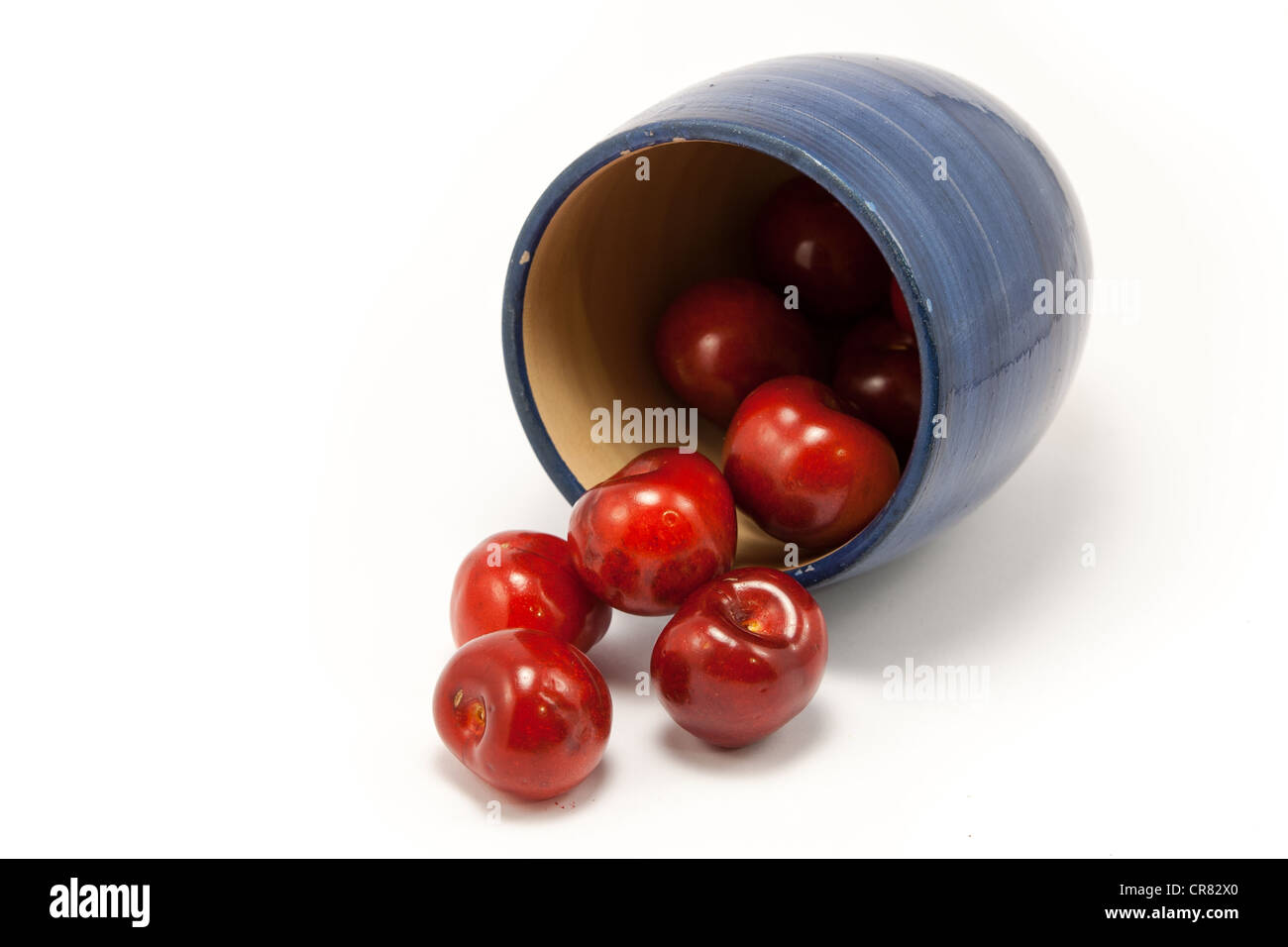 Juicy ruby red cherries in a blue cup Stock Photo - Alamy