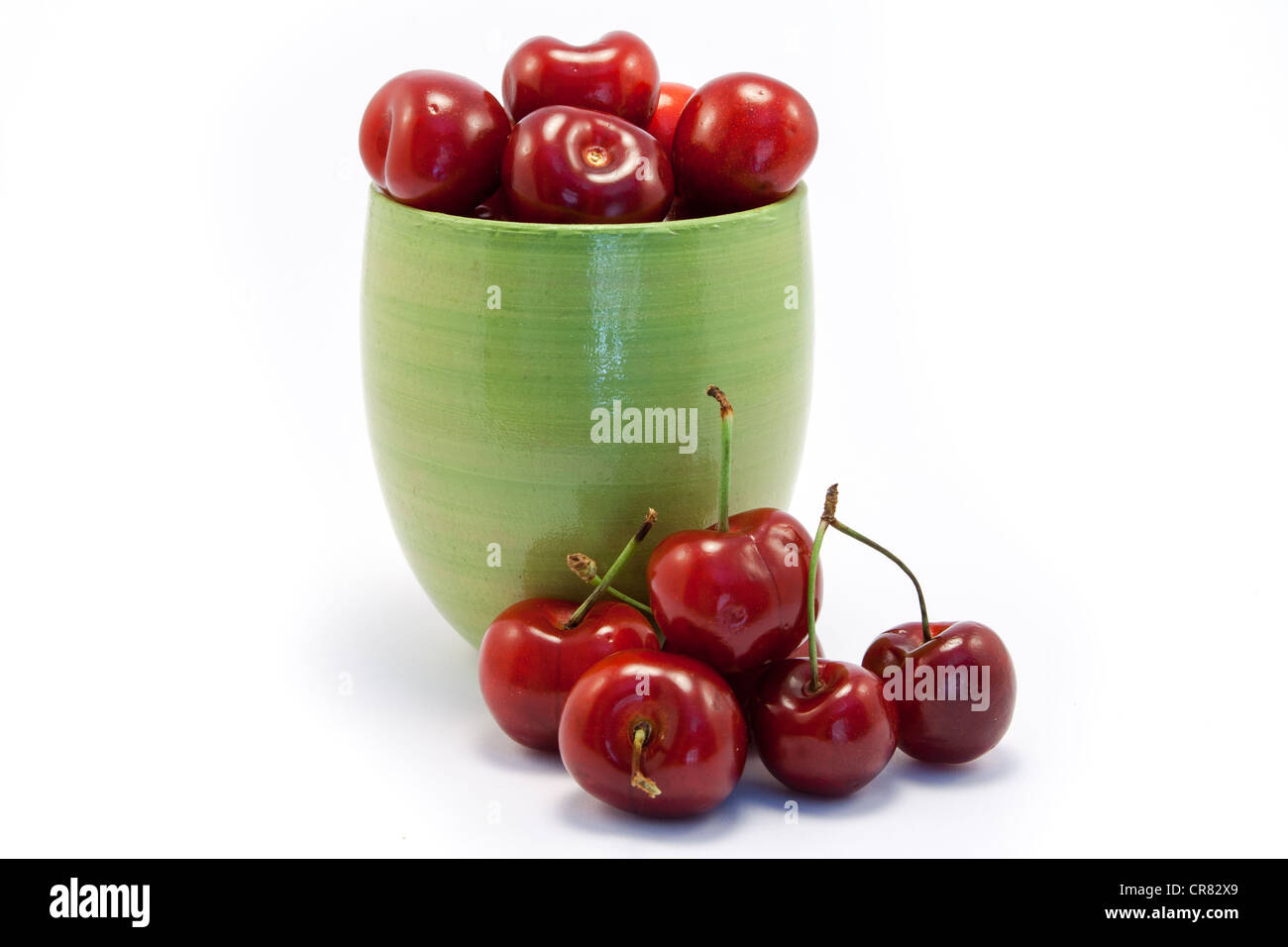Juicy ruby red cherries in a green cup Stock Photo - Alamy