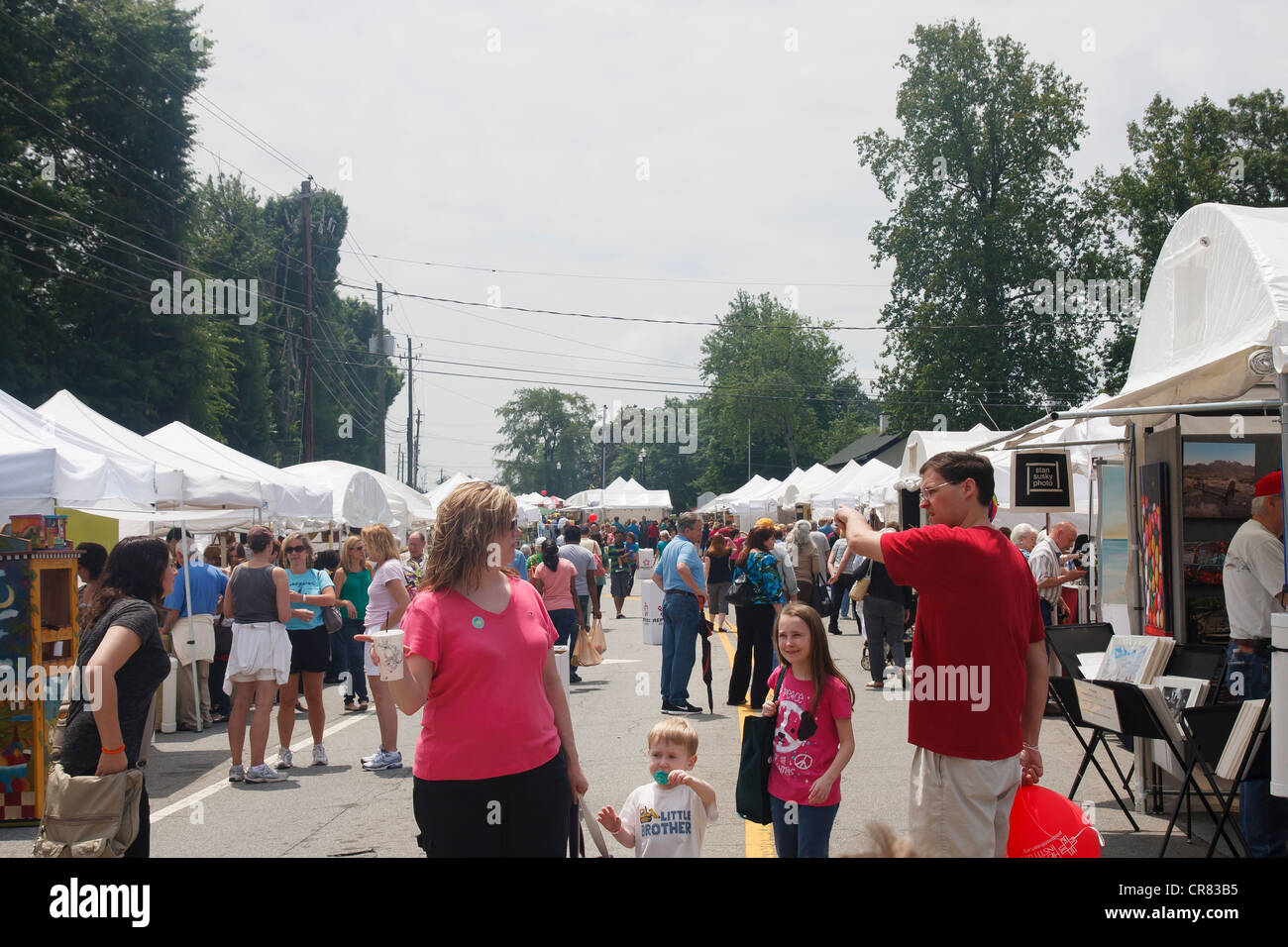 People enjoying an arts and crafts fair in a city street Stock Photo ...