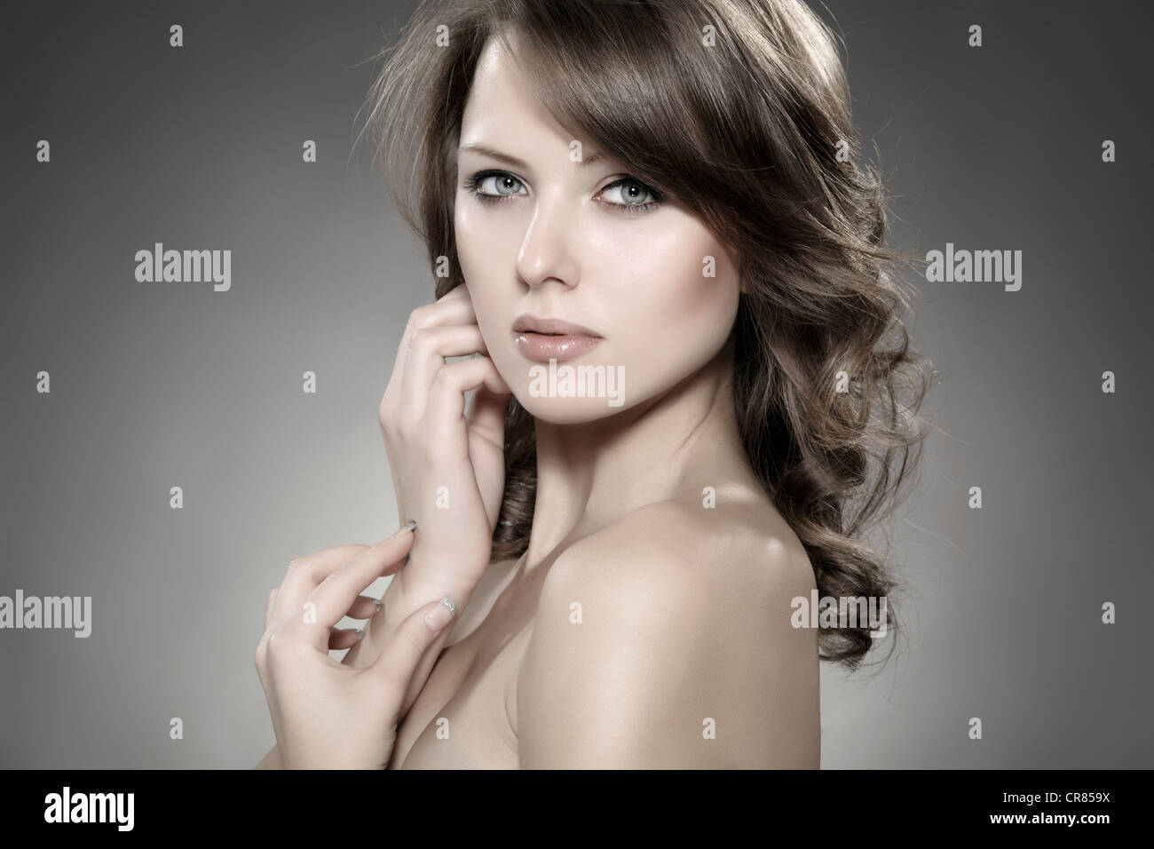 Young woman touching her cheek with her hand, beauty shot, portrait ...