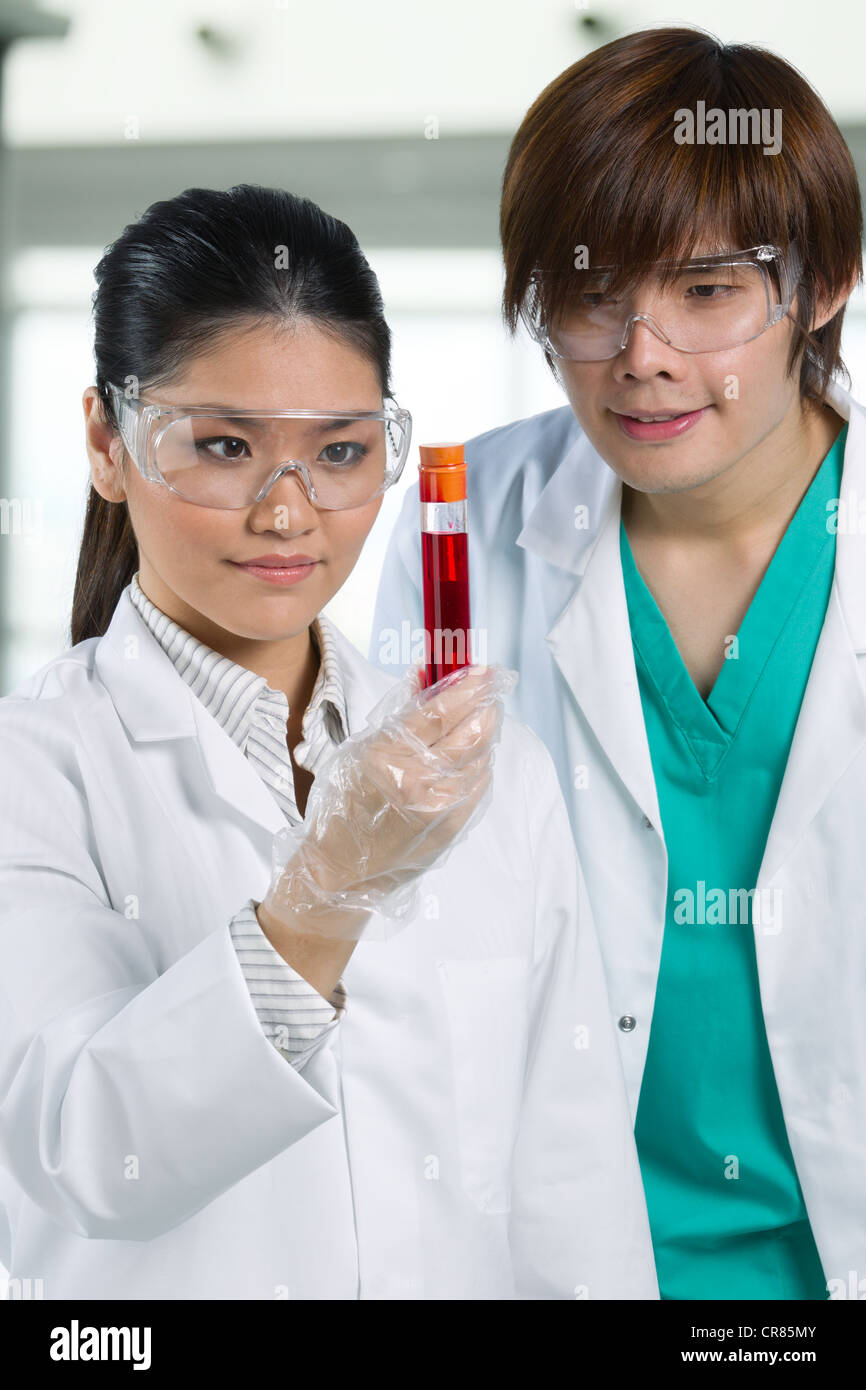 Two scientists analyzing solution Stock Photo - Alamy