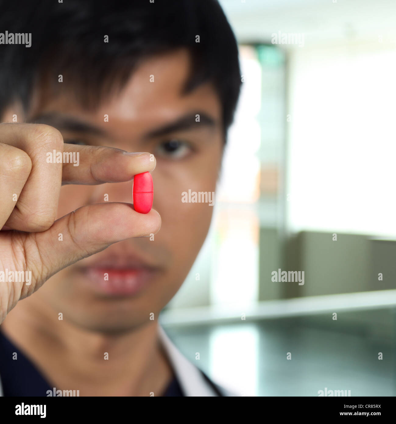 Doctor holding a pill Stock Photo - Alamy