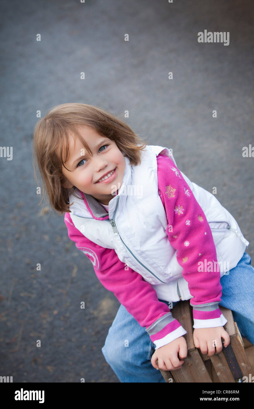 Girl sitting on wooden crate hi-res stock photography and images - Alamy