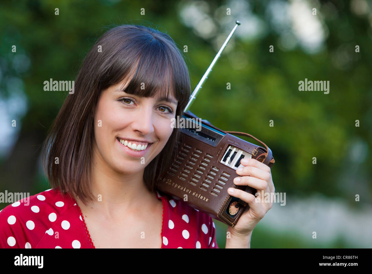Young woman, 25, holding an old radio Stock Photo - Alamy