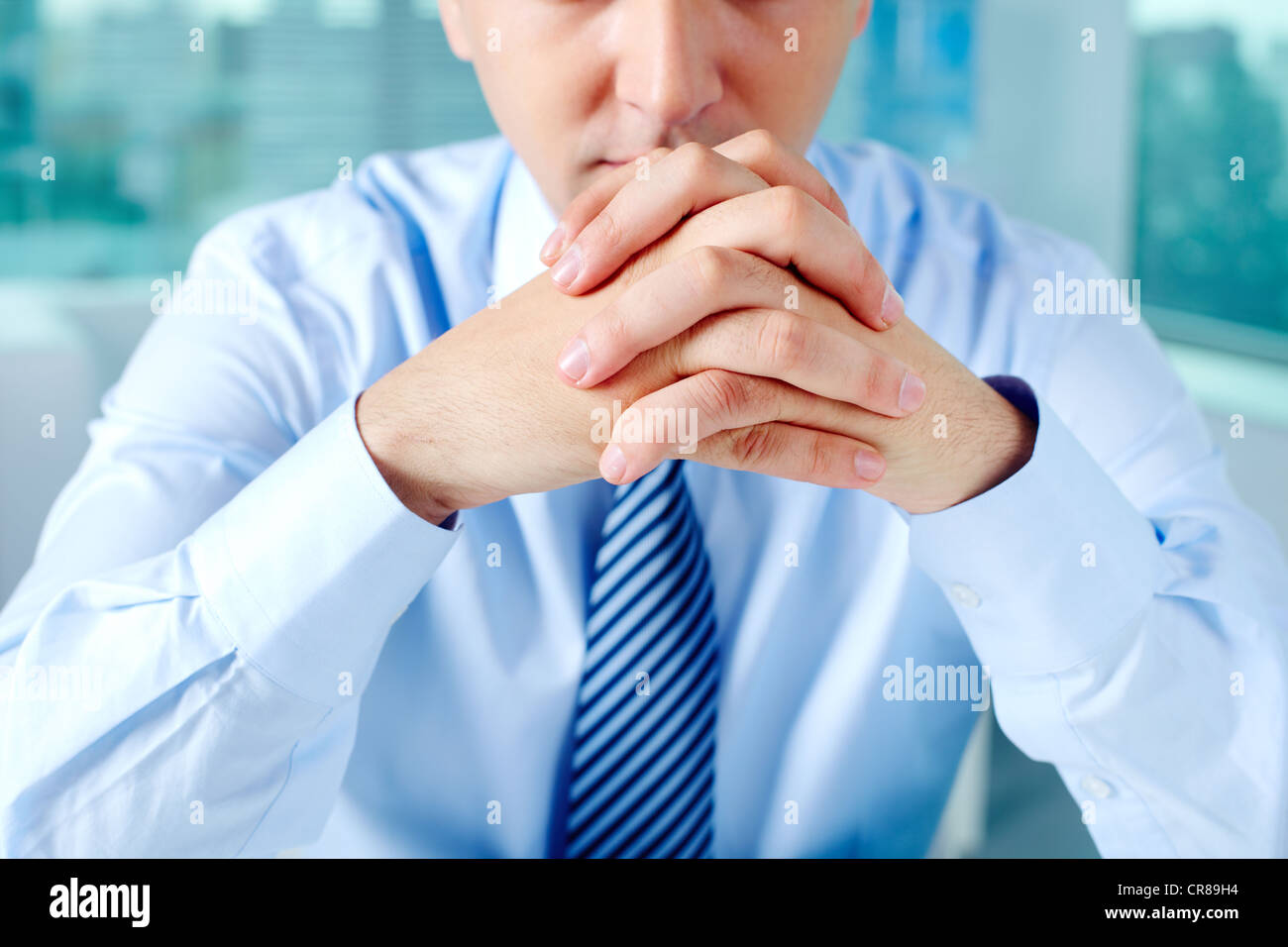 Close-up of businessman keeping fingers crossed by his face Stock Photo ...