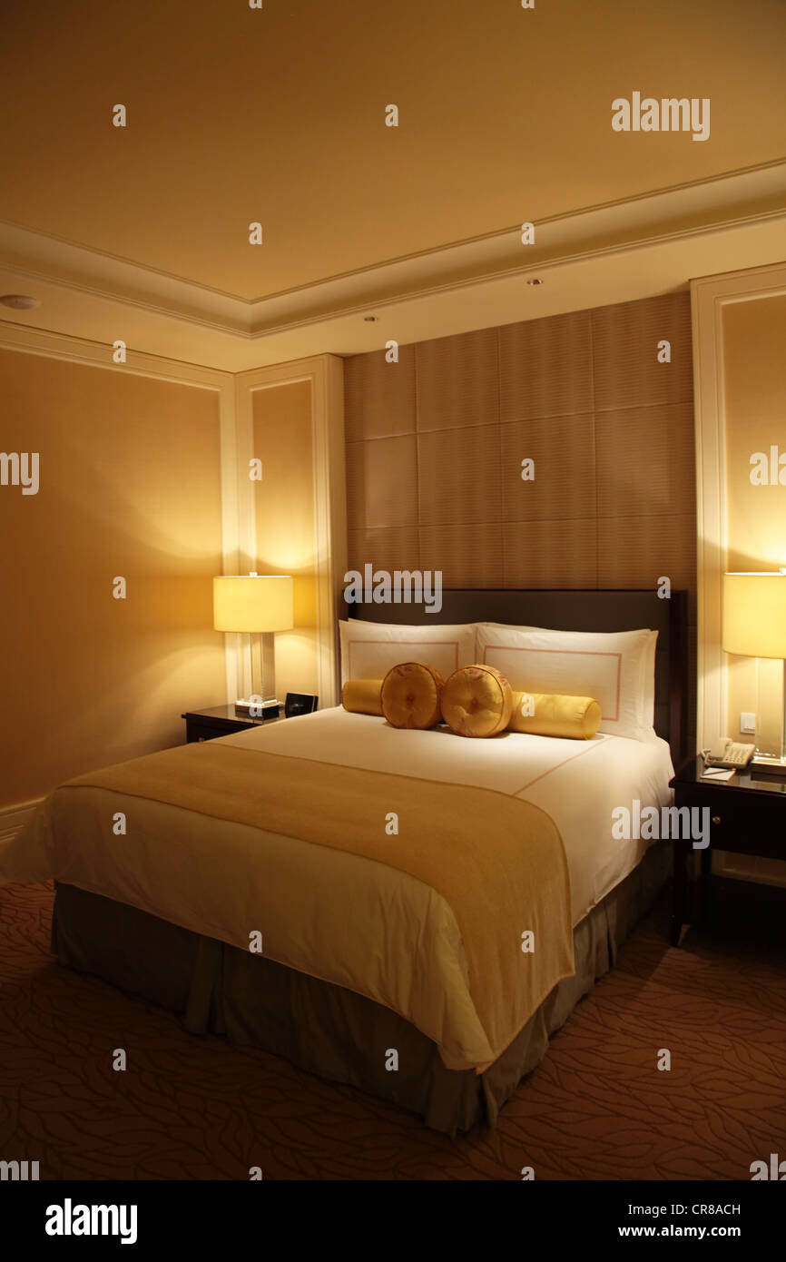 Luxury Hotel Room at Night in Bedroom Stock Photo - Alamy