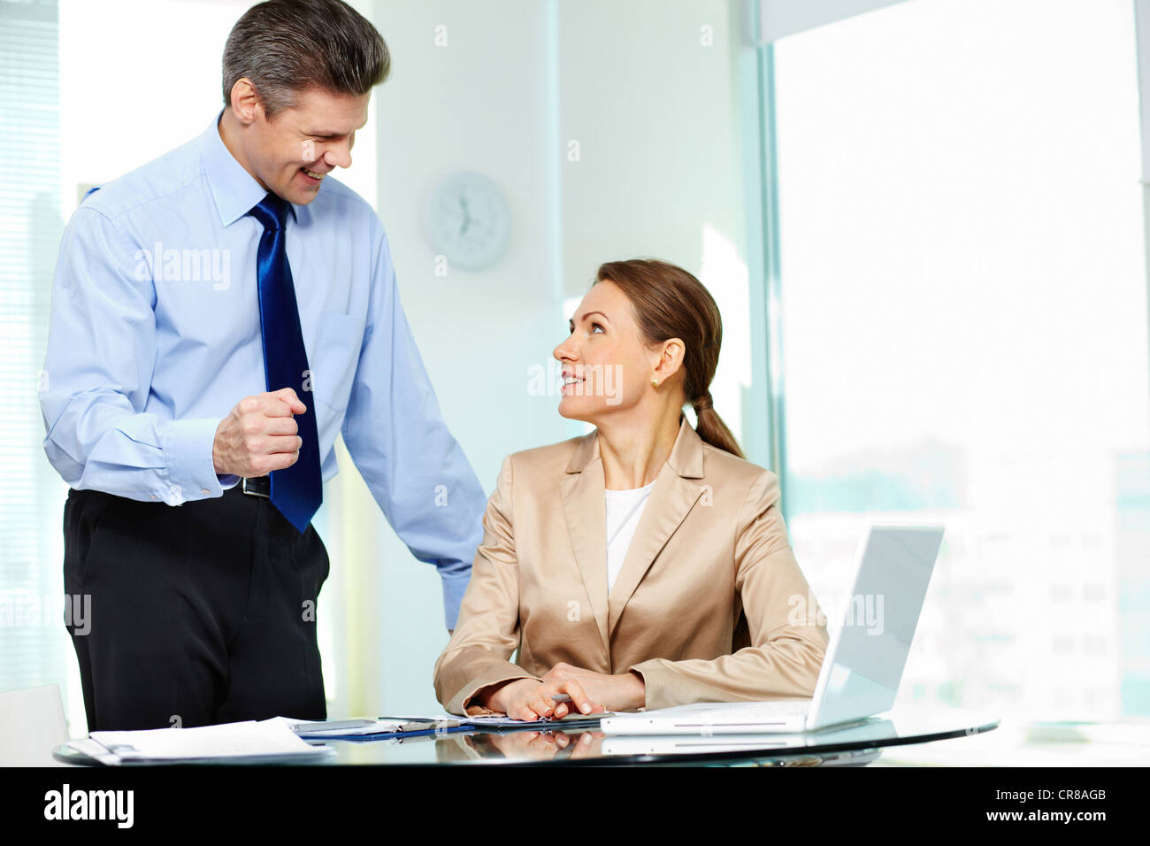 Experienced businessman explaining some business matters to his ...