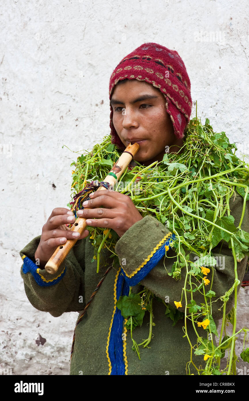 Peru, Cuzco Province, Huaro, young playing flute in traditional dress ...